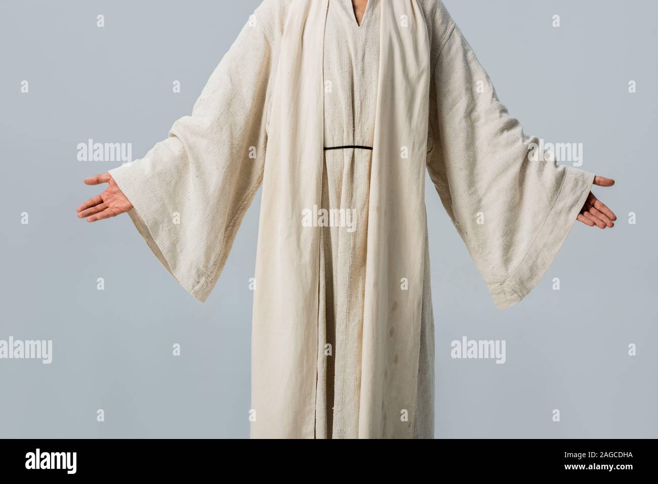 cropped view of man in jesus robe with outstretched hands isolated on ...