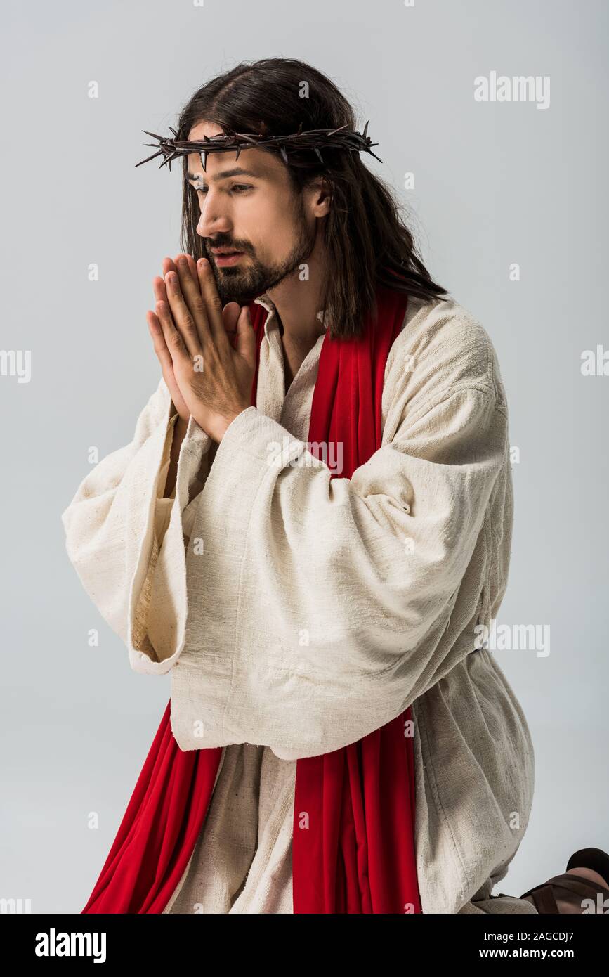 religious man with praying hands and jesus robe isolated on grey Stock ...