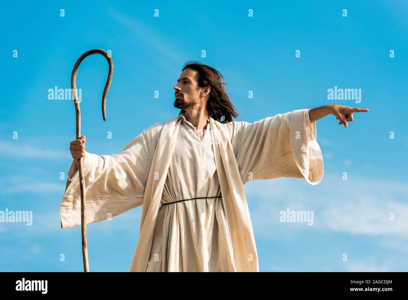 man in jesus robe holding wooden cane and pointing with finger Stock ...