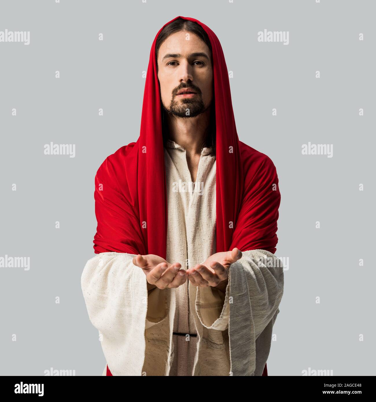 religious man standing with cupped hands and looking at camera isolated ...