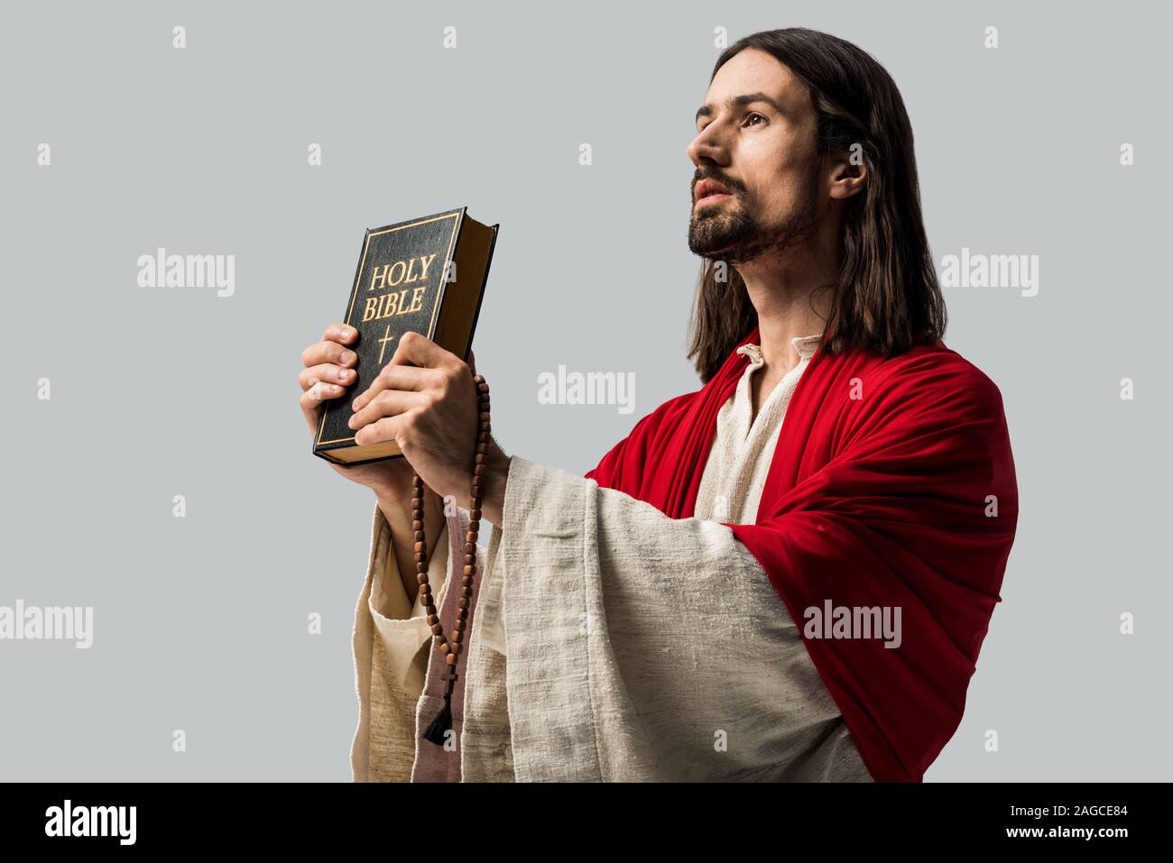 handsome jesus holding holy bible isolated on grey Stock Photo - Alamy