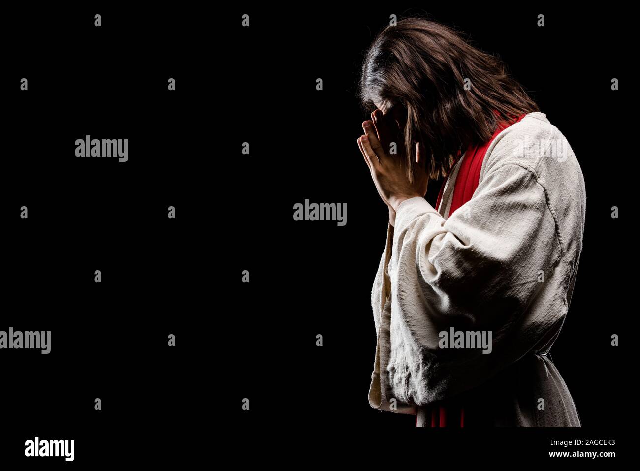 religious man covering face while praying isolated on black Stock Photo ...