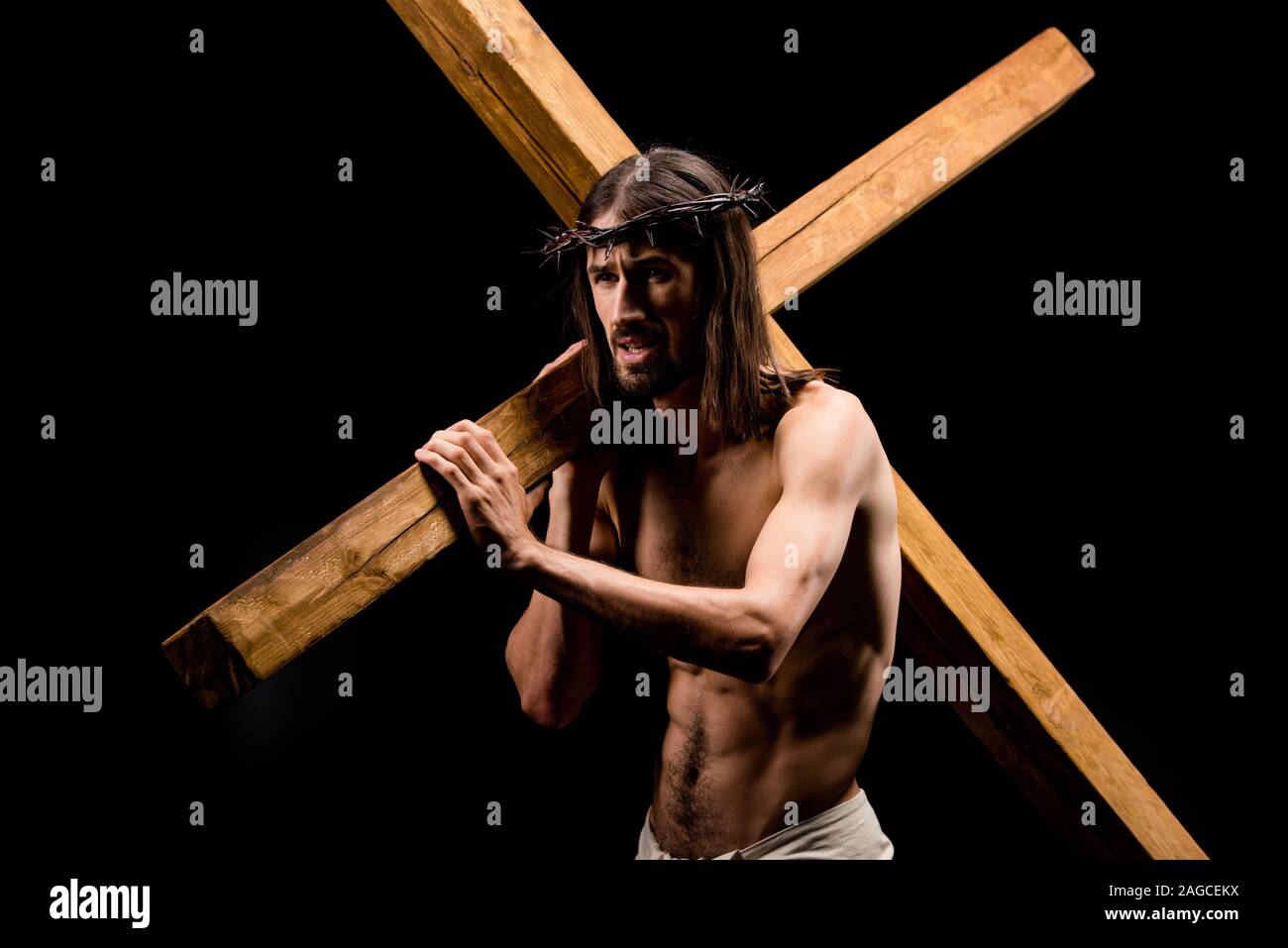 jesus in wreath with spikes holding heavy wooden cross isolated on ...