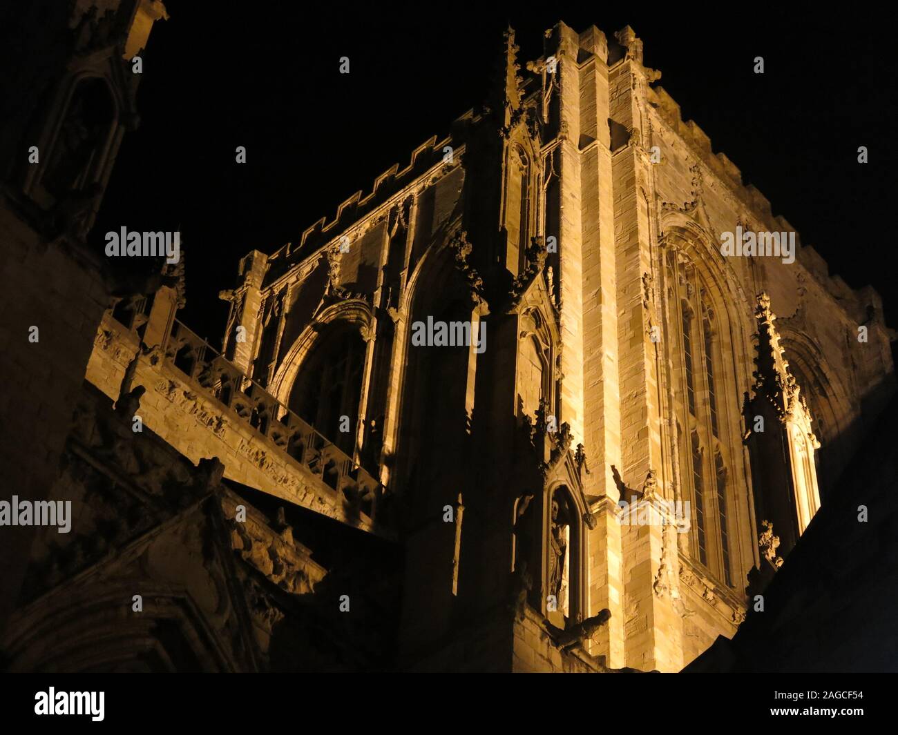 A corner of the building illuminated at night showing the ornate gothic ...