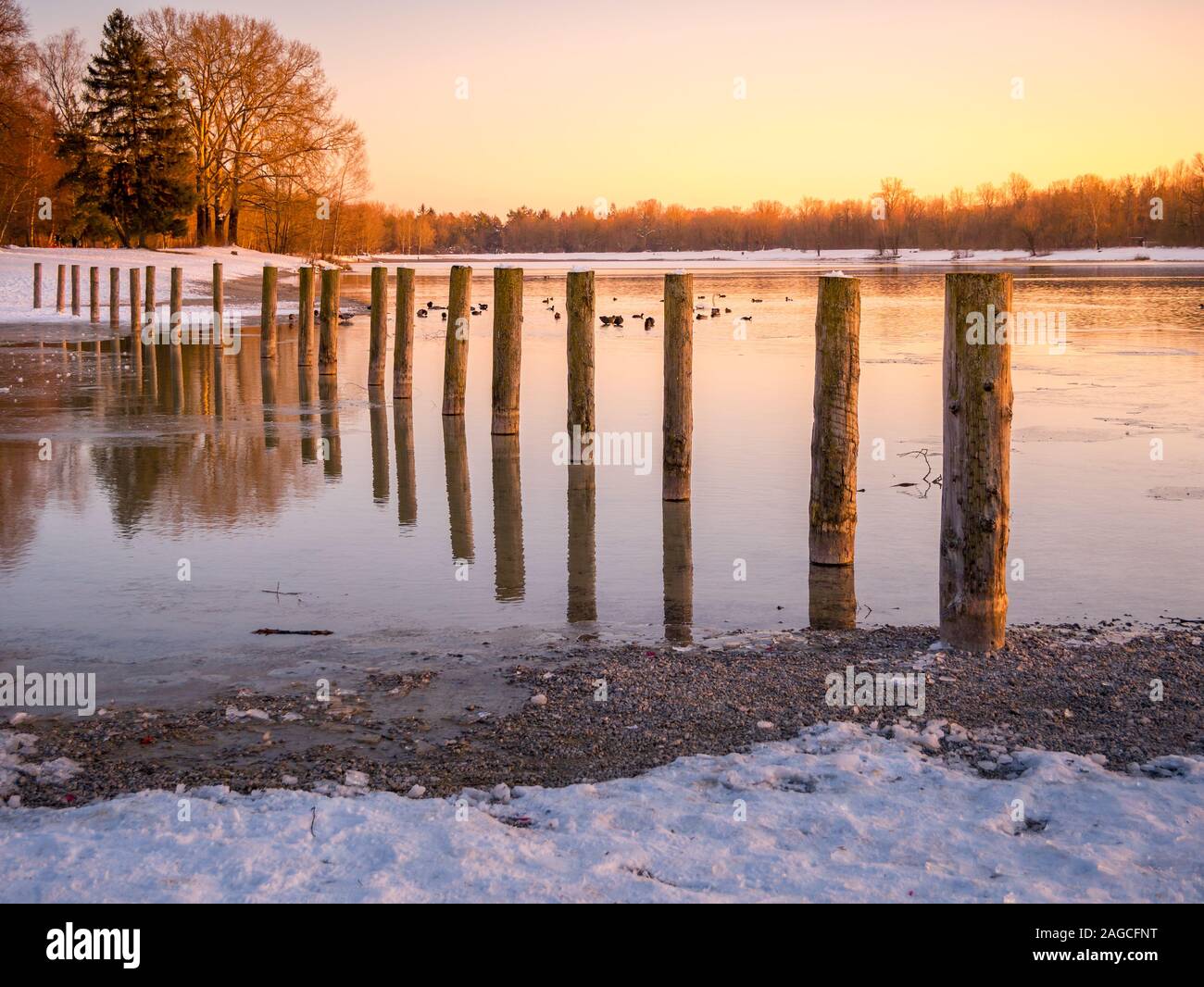 Image of wooden pillars in water during sunset Stock Photo - Alamy