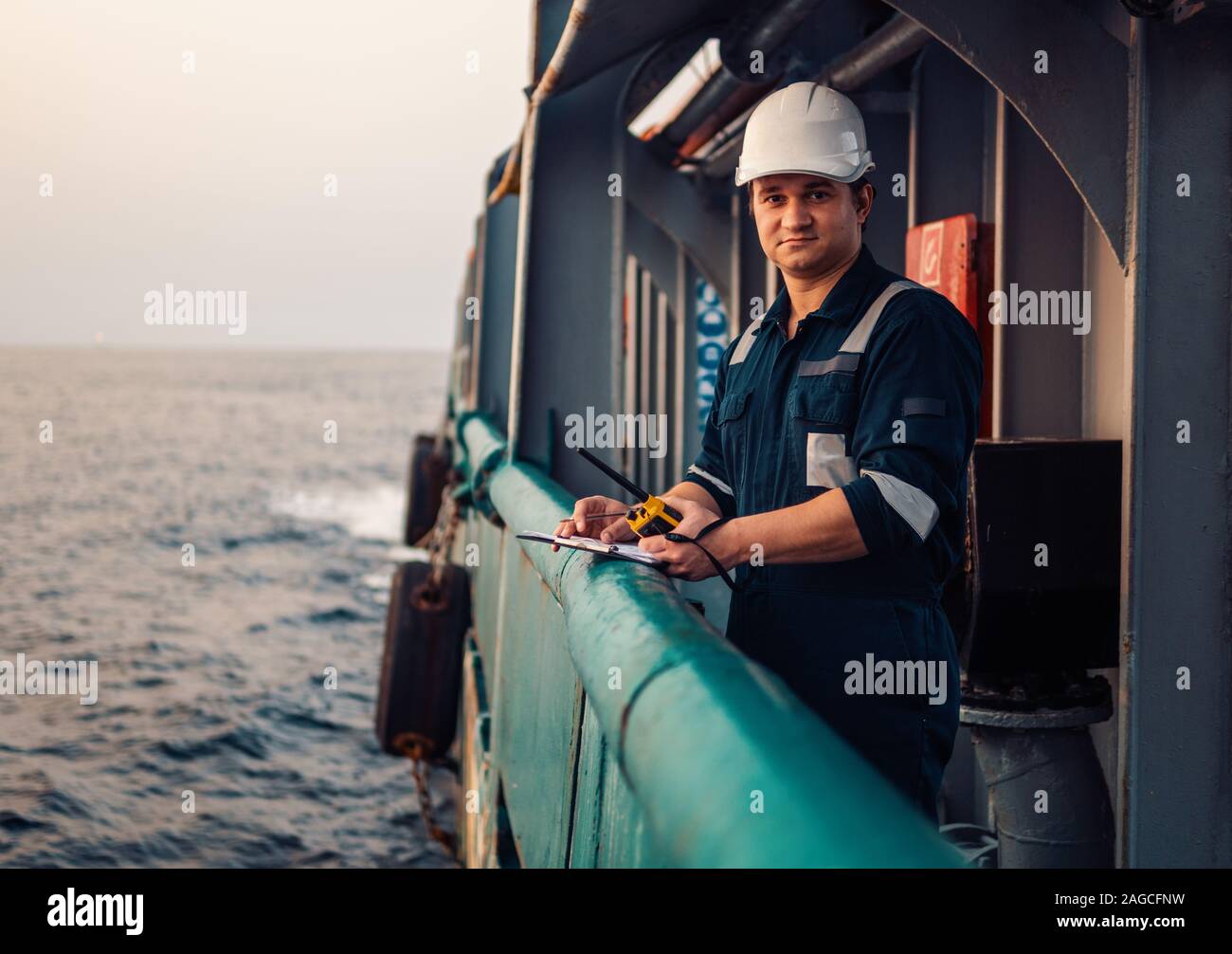 Deck Officer on deck of offshore vessel or ship , wearing PPE personal ...