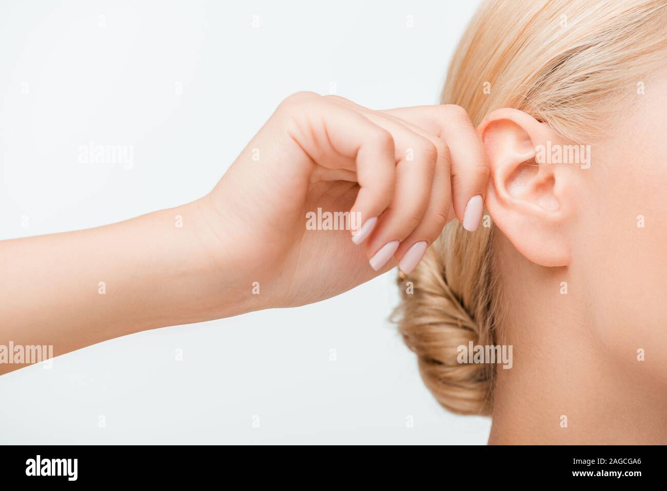 cropped view of blonde girl touching ear while listening isolated on ...