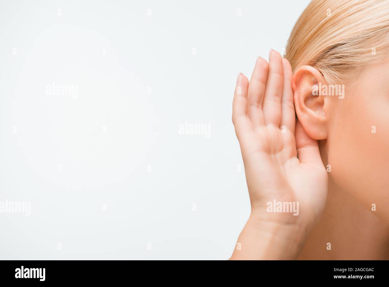 cropped view of blonde woman touching ear while listening isolated on ...