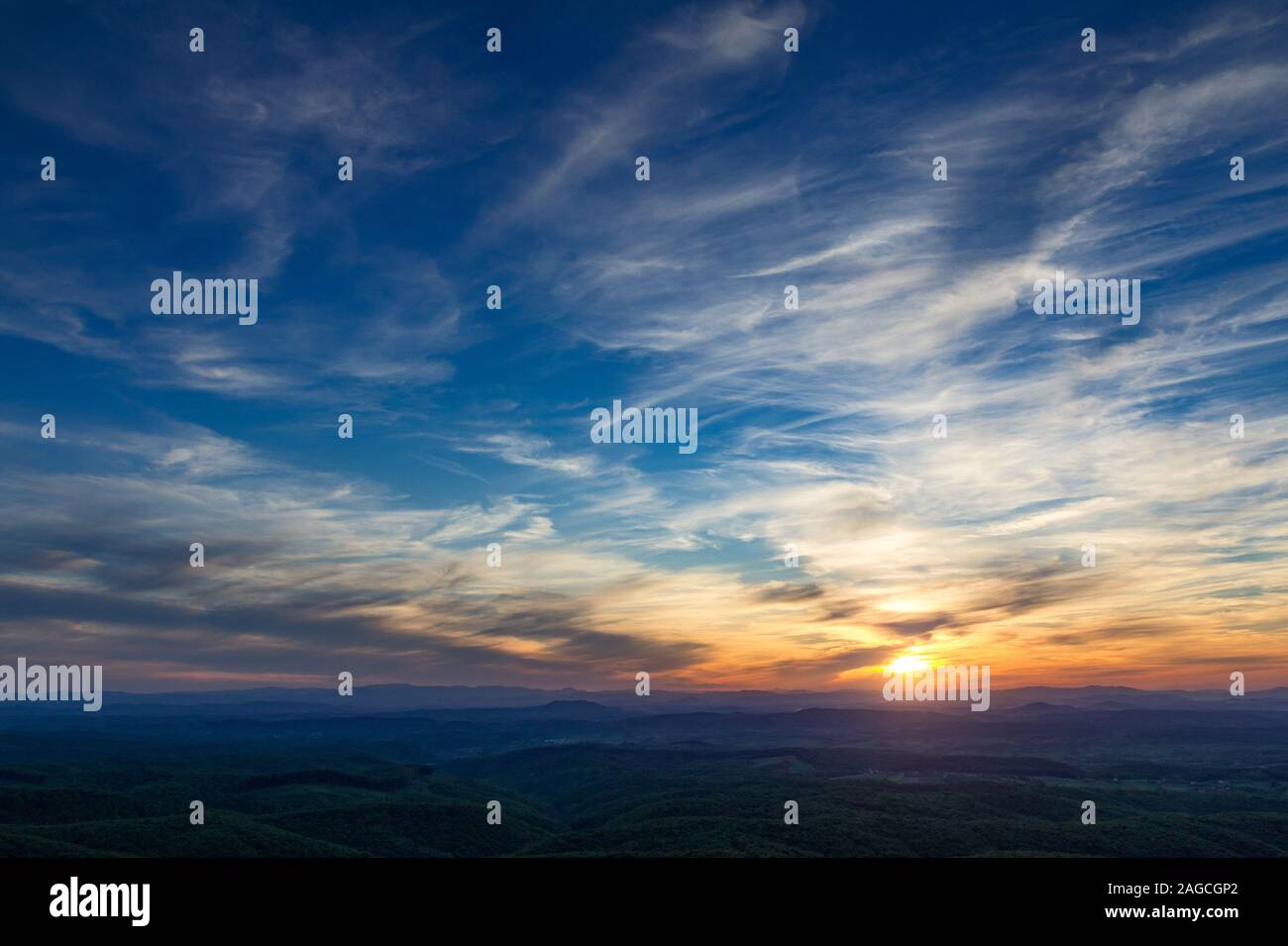 Breathtaking sunset scenery with the golden sun in the cloudy sky ...