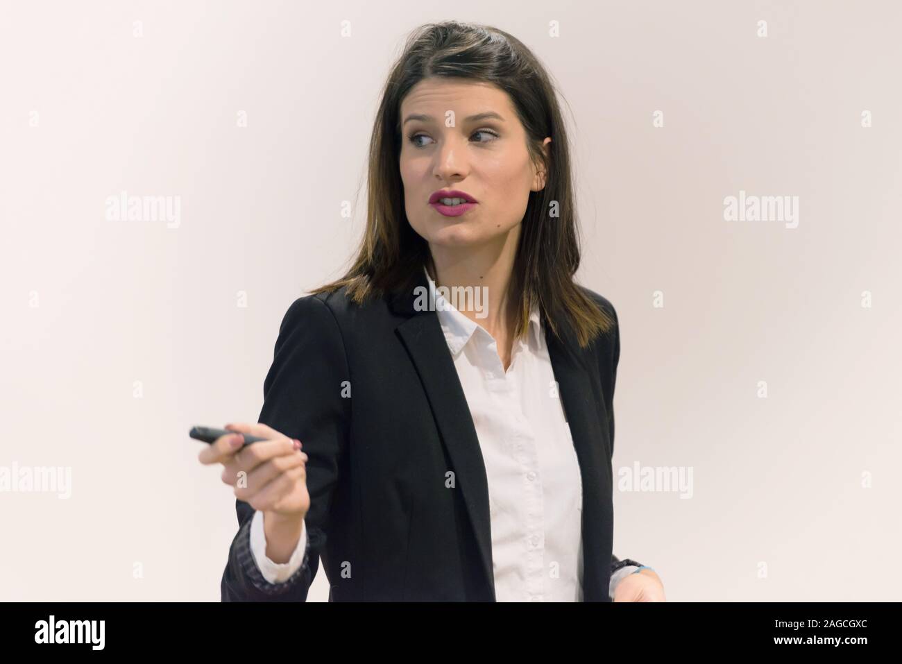 Pretty young businesswoman, teacher or mentor coach speaking to young ...