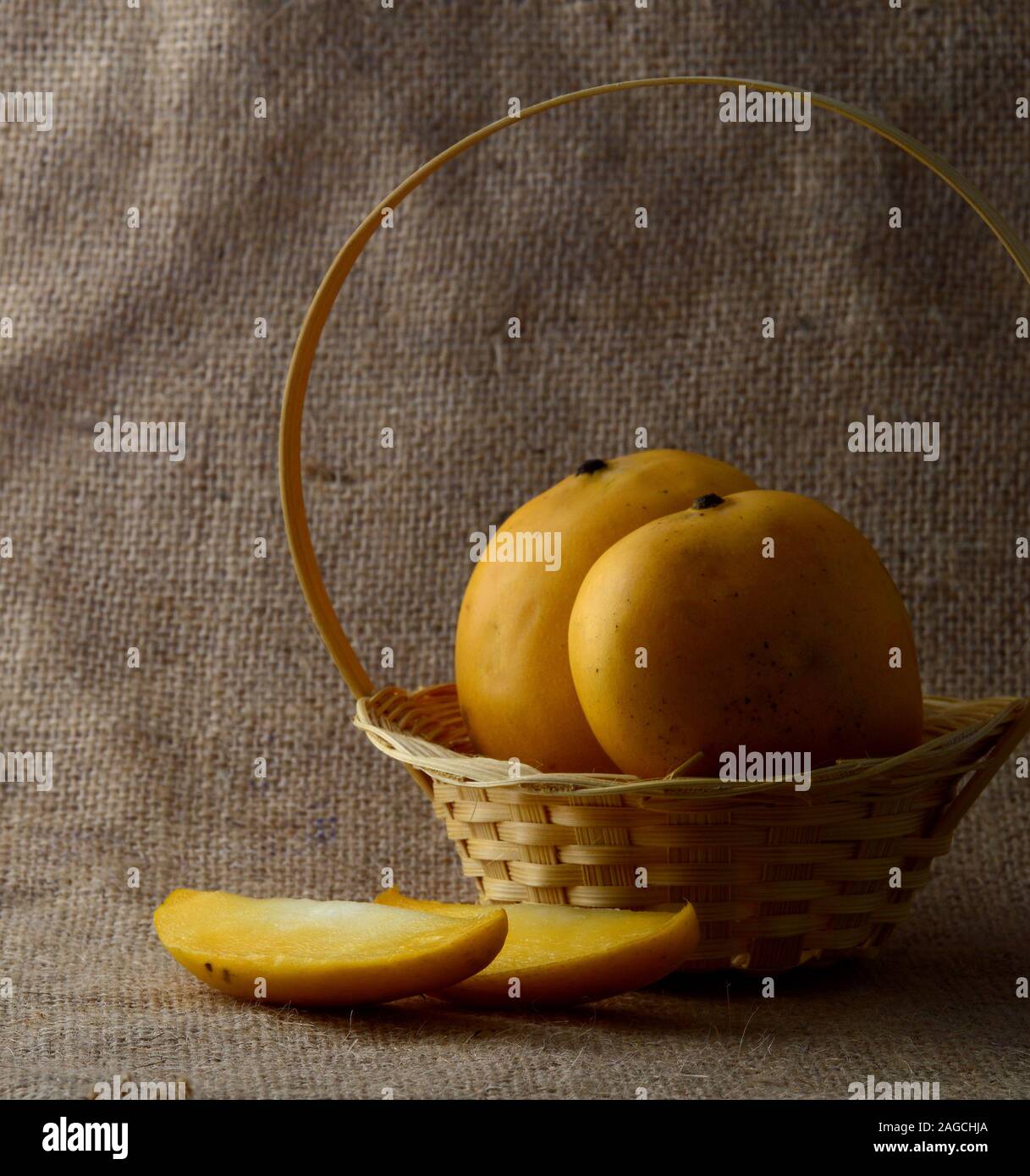 Mango fruit in basket on sack cloth background Stock Photo - Alamy