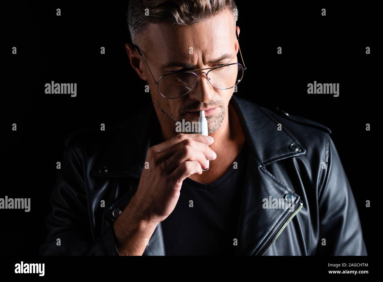 KYIV, UKRAINE - OCTOBER 11, 2019: Handsome pensive man smoking iqos ...