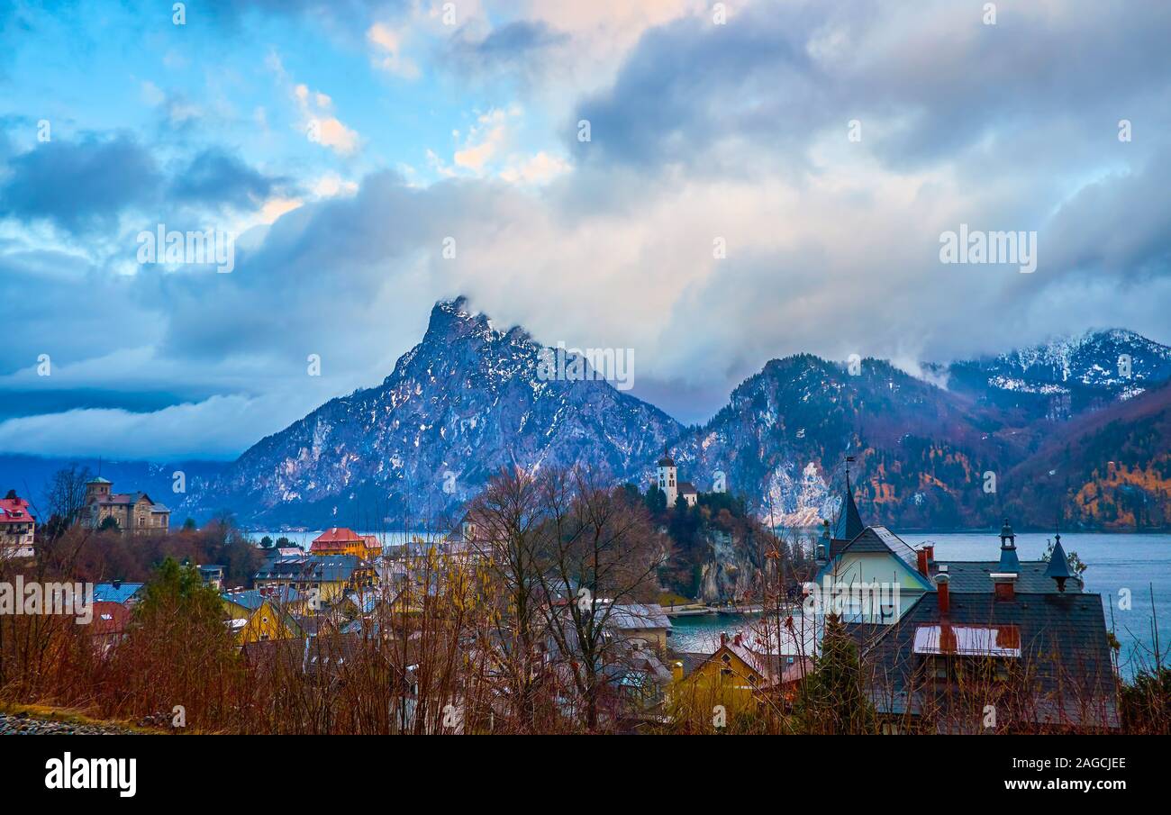 The quiet foggy evening in Traunkirchen, fast clouds run around ...