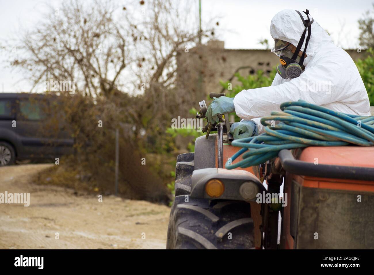 Tractor spraying pesticide and insecticide on lemon plantation in Spain ...