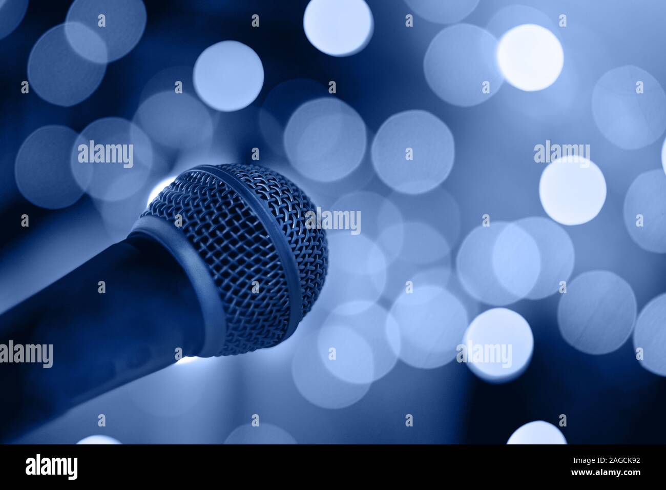 Microphone on stage with bokeh lights Stock Photo - Alamy