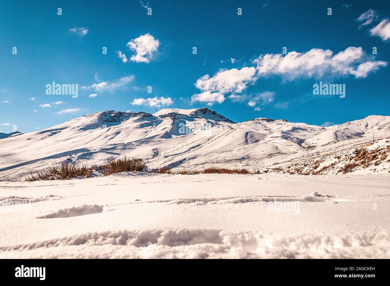 Beautiful low angle shot of a breathtaking mountainous scenery covered ...