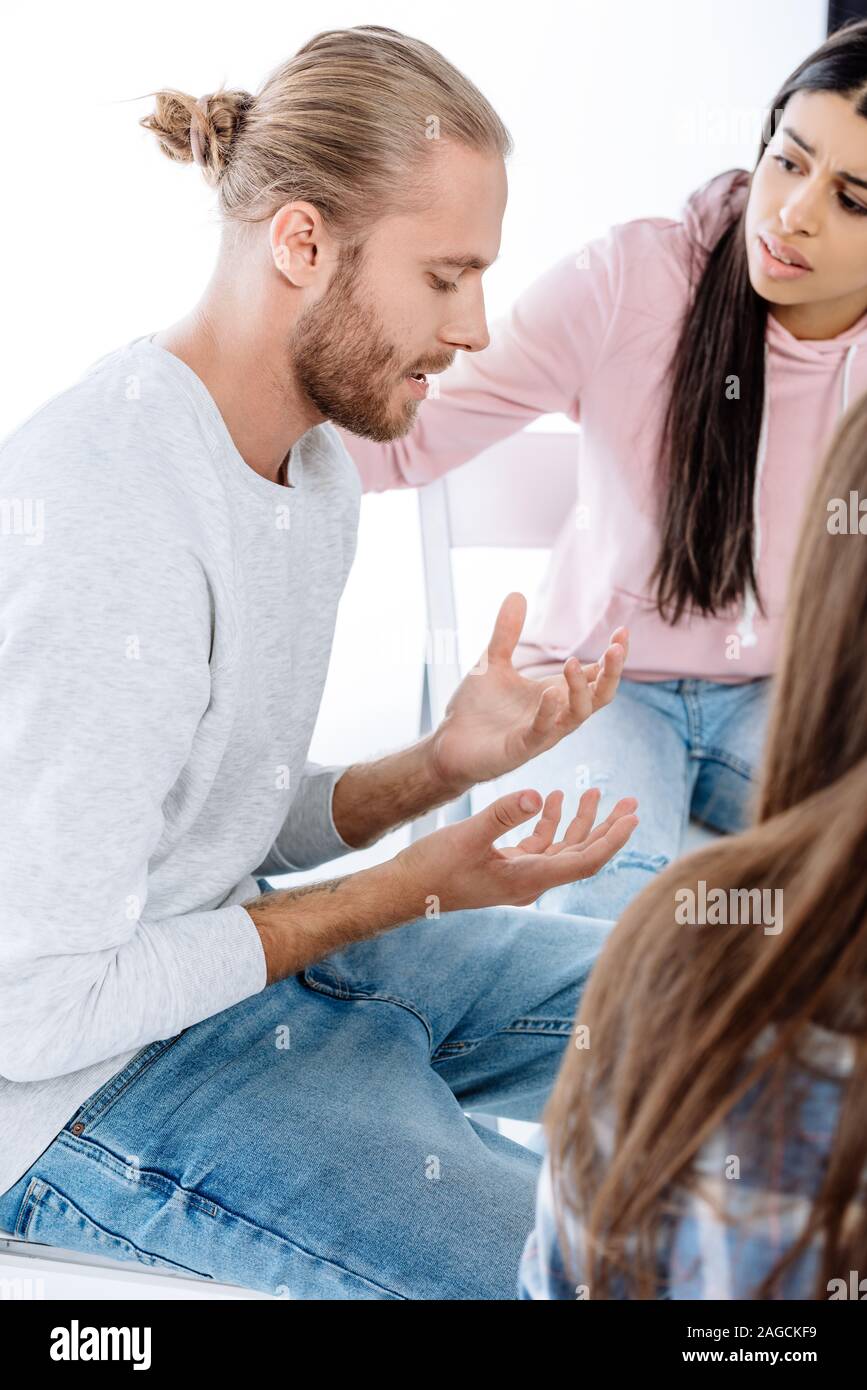 support group helping sad man on chair isolated on white Stock Photo ...
