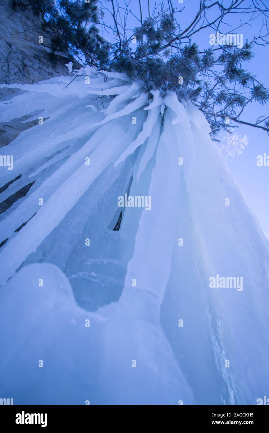 Large icecycles hanging from a cliff wall outside in the winter Stock ...