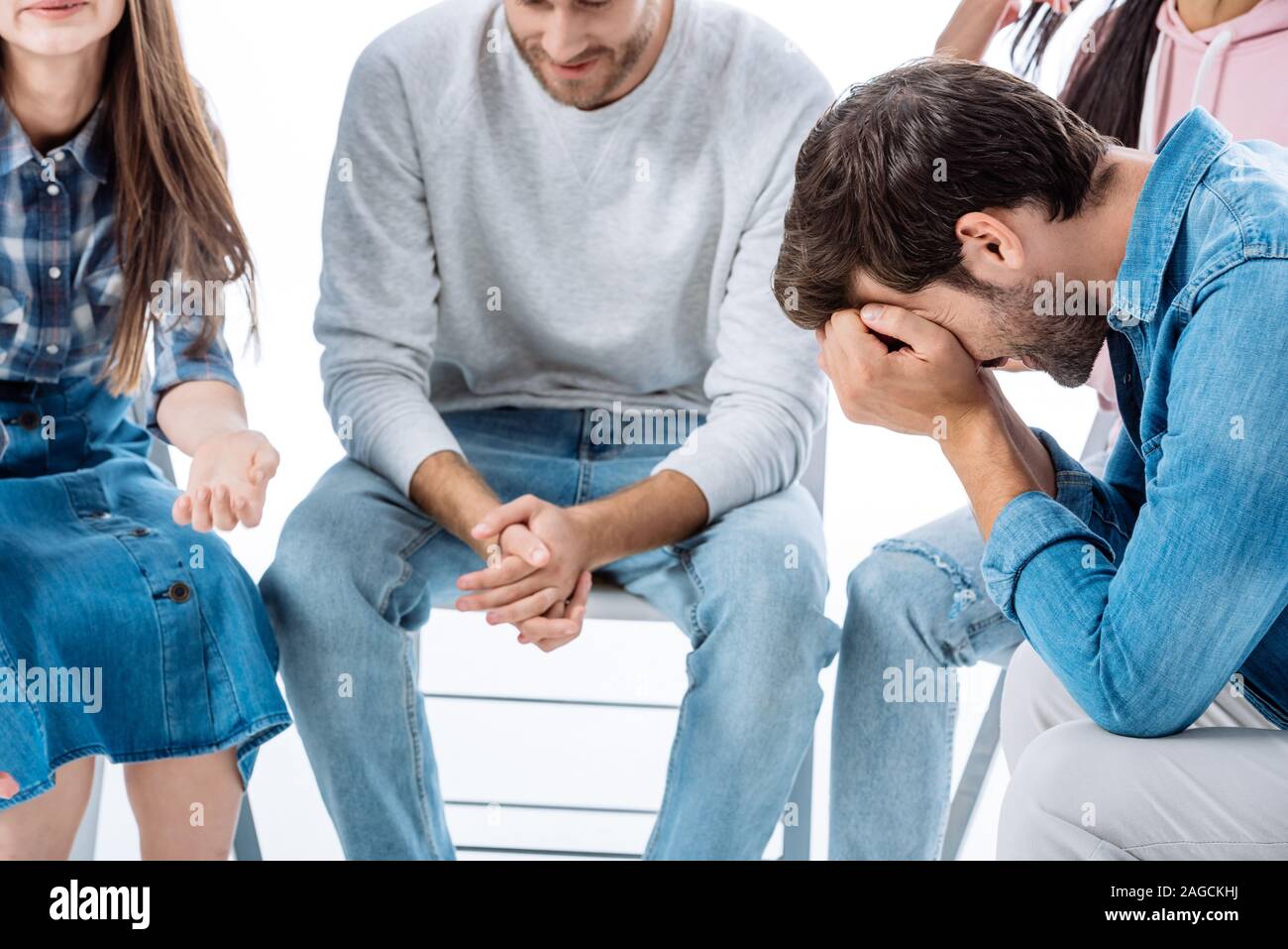 sad man sitting on chair near support group isolated on white Stock ...
