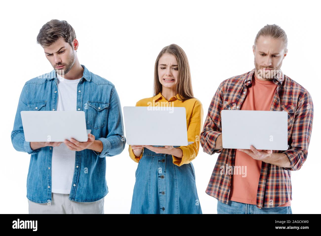 confused young friends holding laptops isolated on white Stock Photo ...