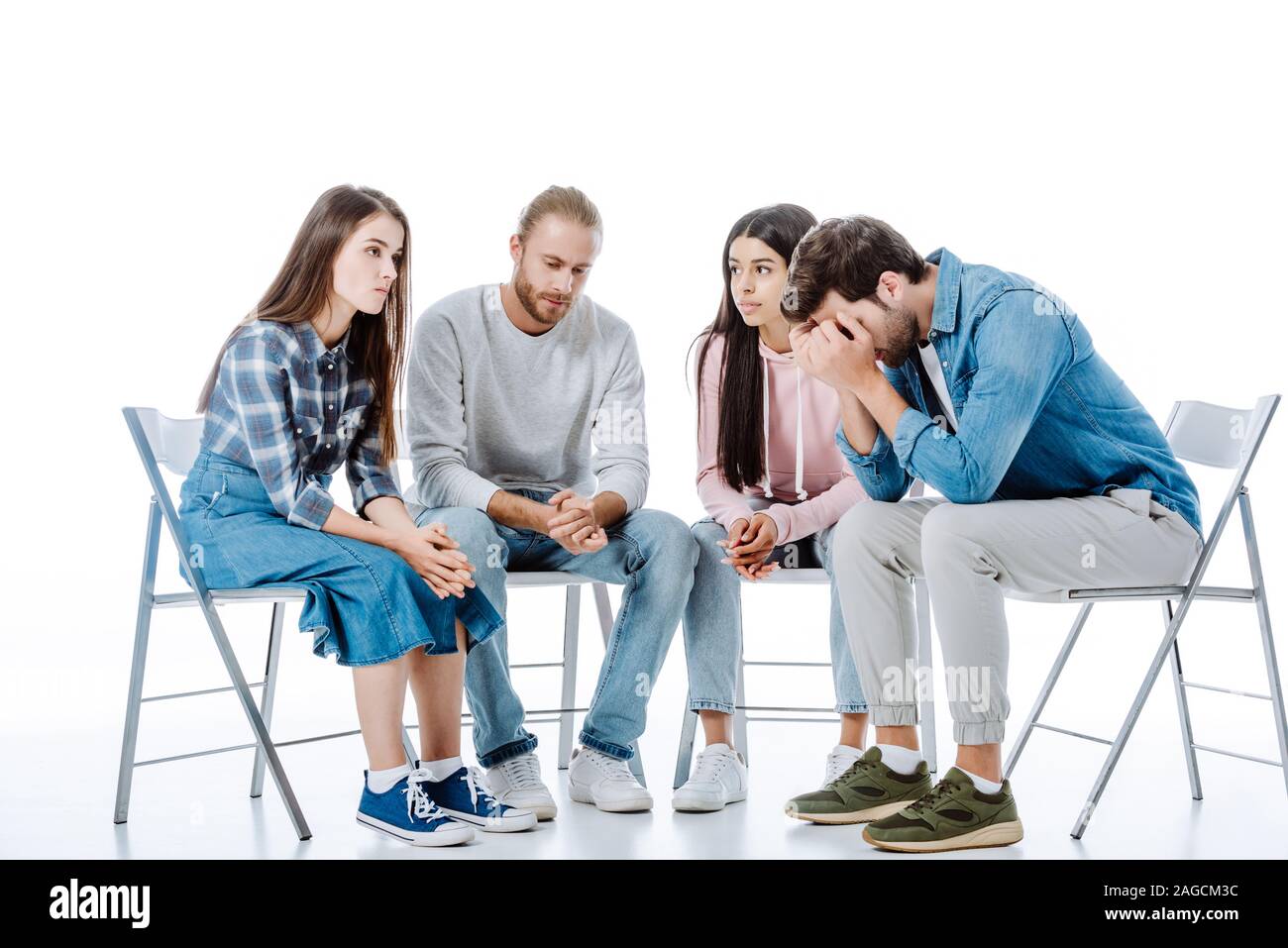sad multicultural support group sitting on chairs isolated on white ...