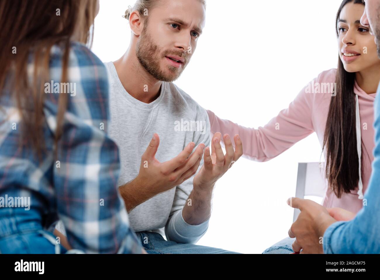 multicultural support group helping sad man on chair isolated on white ...