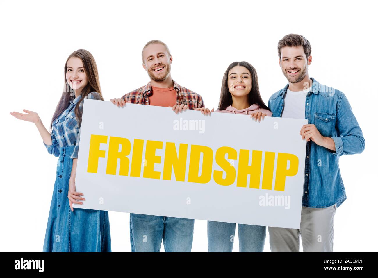 happy multicultural friends holding placard with yellow friendship ...