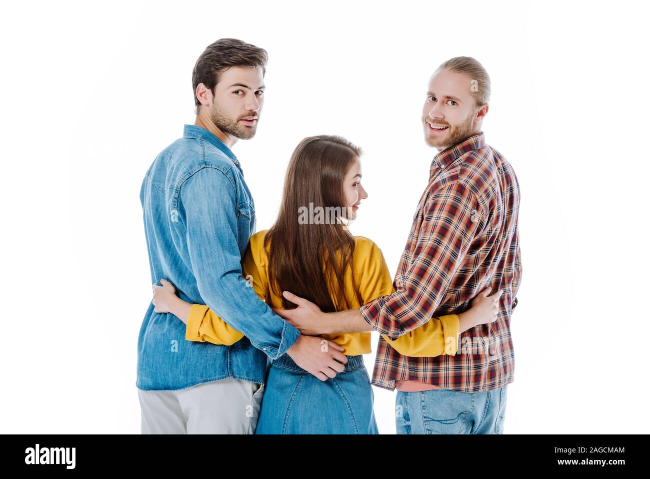 back view of three smiling young friends hugging isolated on white ...