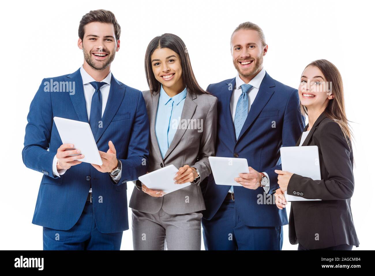 smiling multicultural business people in suits holding digital tablets ...