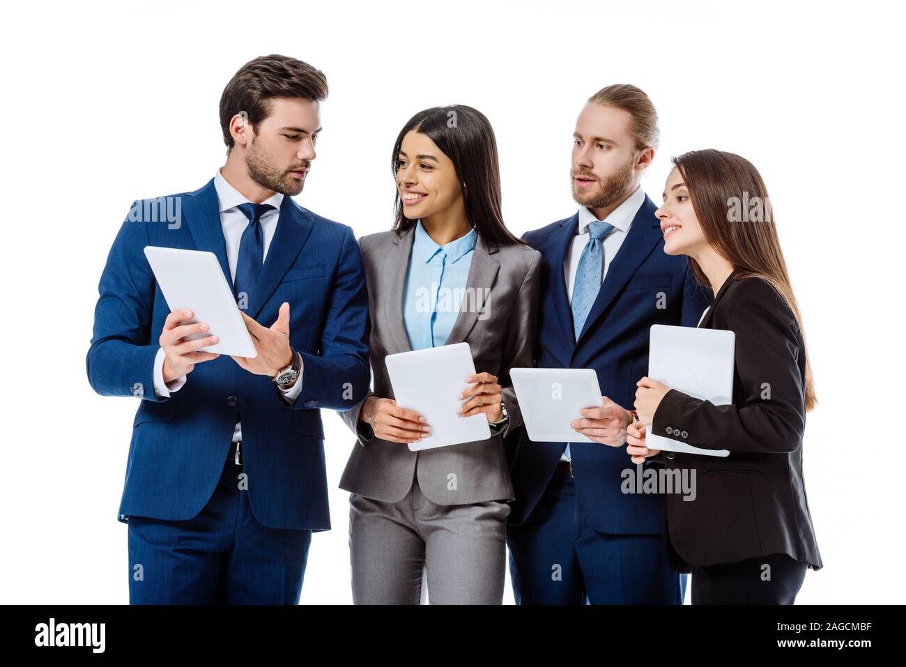 smiling multicultural business people in suits using digital tablets ...