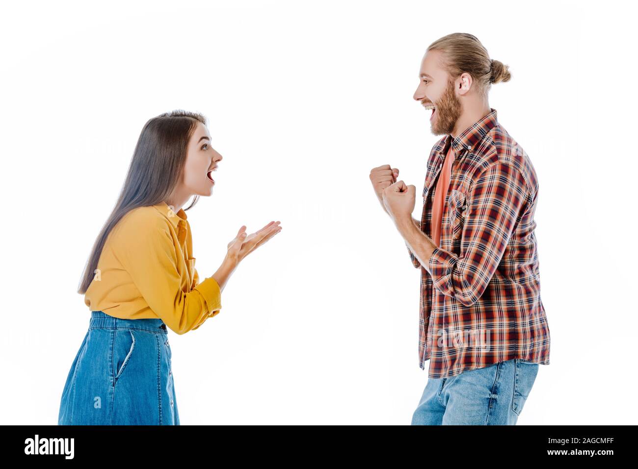 side view of happy young couple in casual outfit showing yeah gesture ...