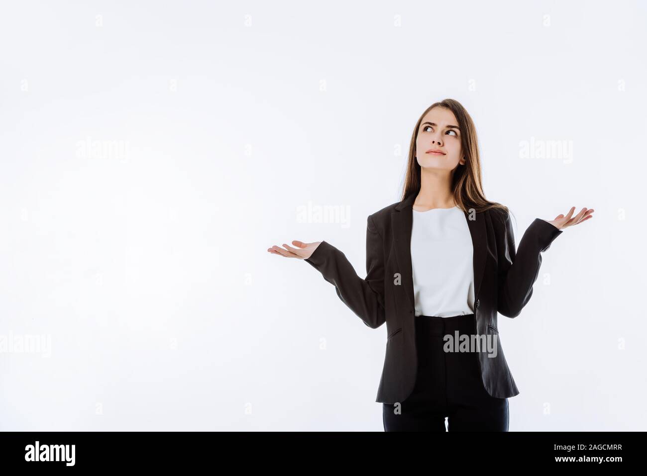 confused businesswoman in suit showing shrug gesture isolated on white ...