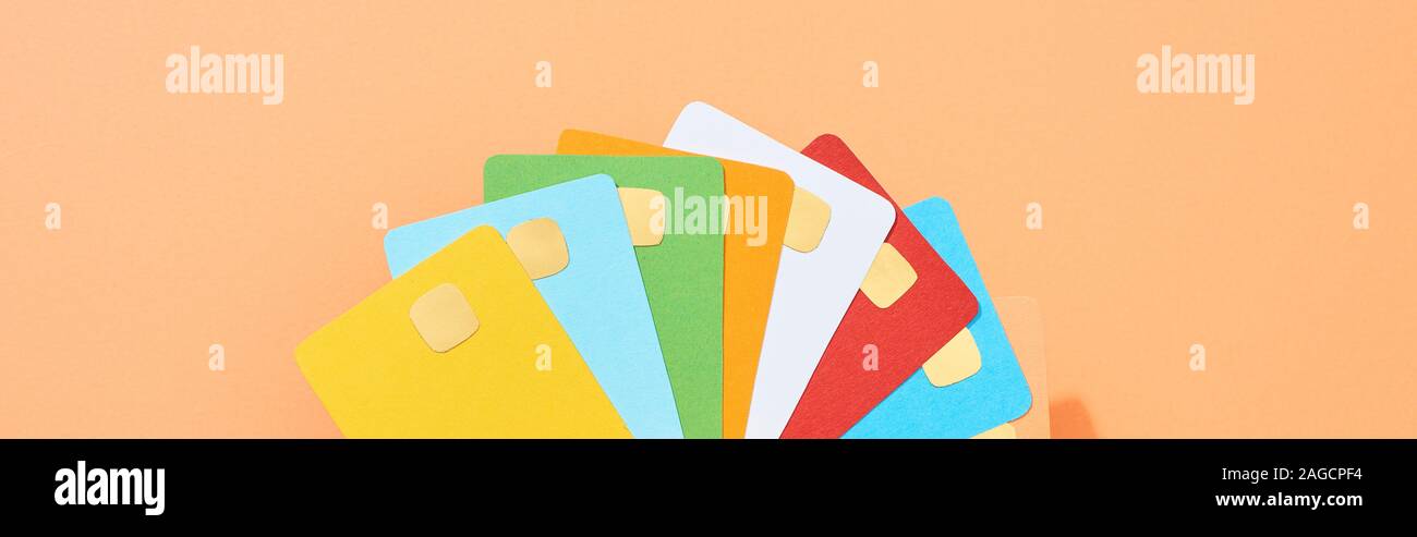 top view of multicolored empty credit cards on peach background ...