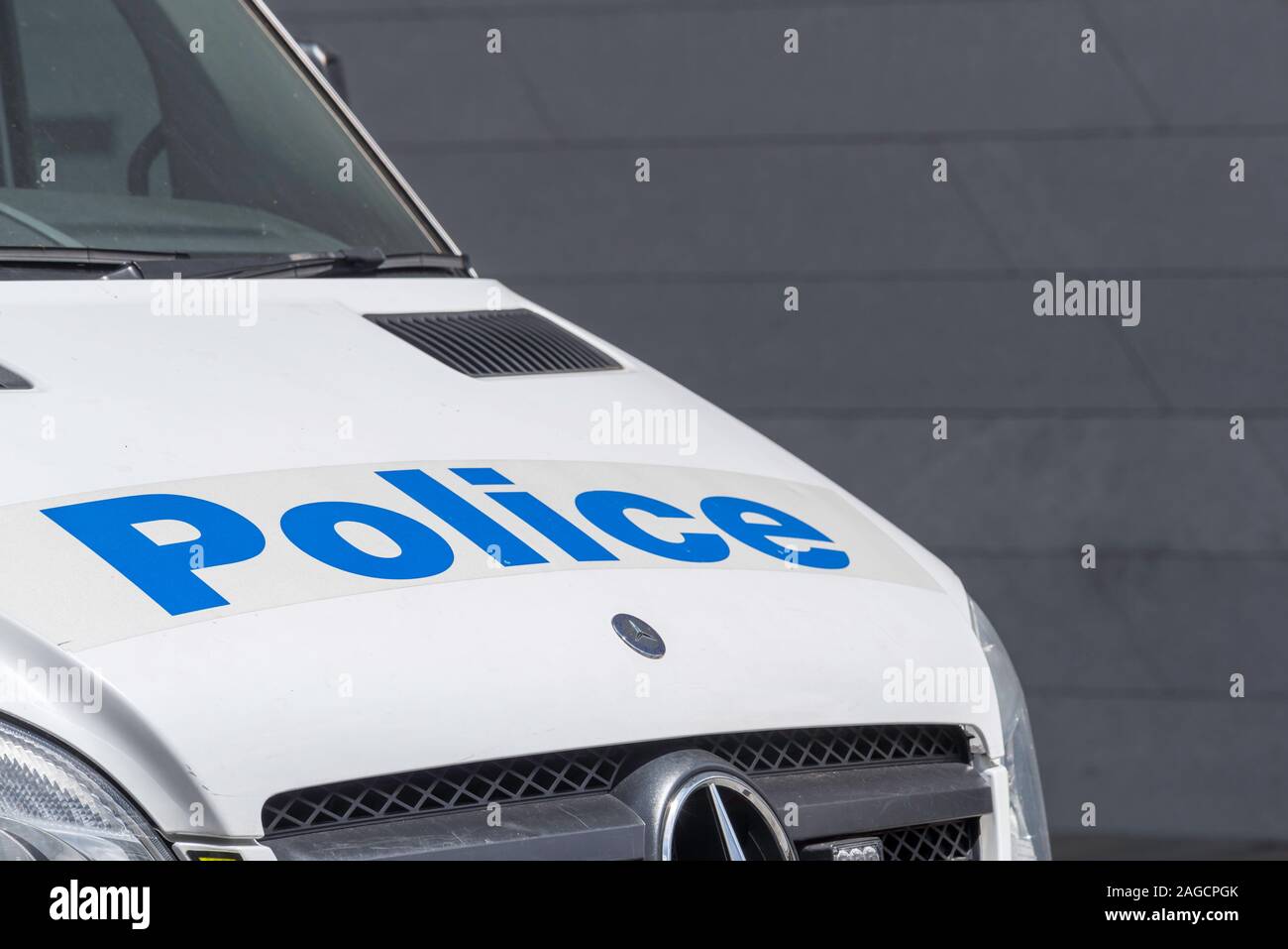 A partial view of a white police van and the word Police written in ...