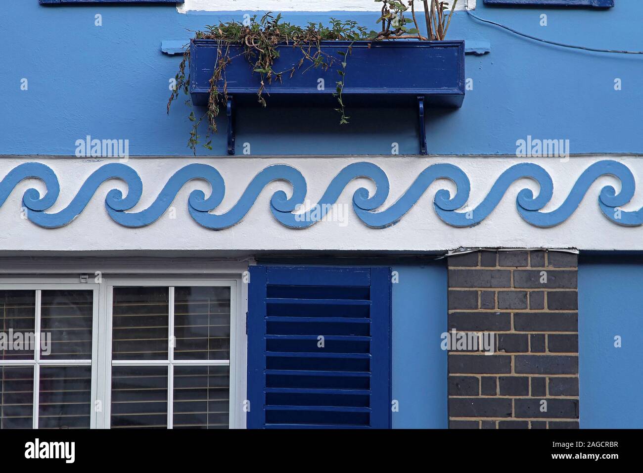 Decorative blue wave ornament at house facade Stock Photo - Alamy