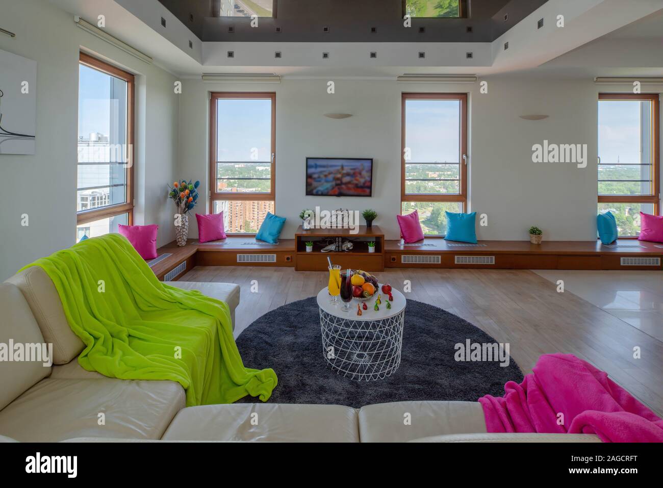 Living room in modern spacious apartment. View of wall with windows and ...
