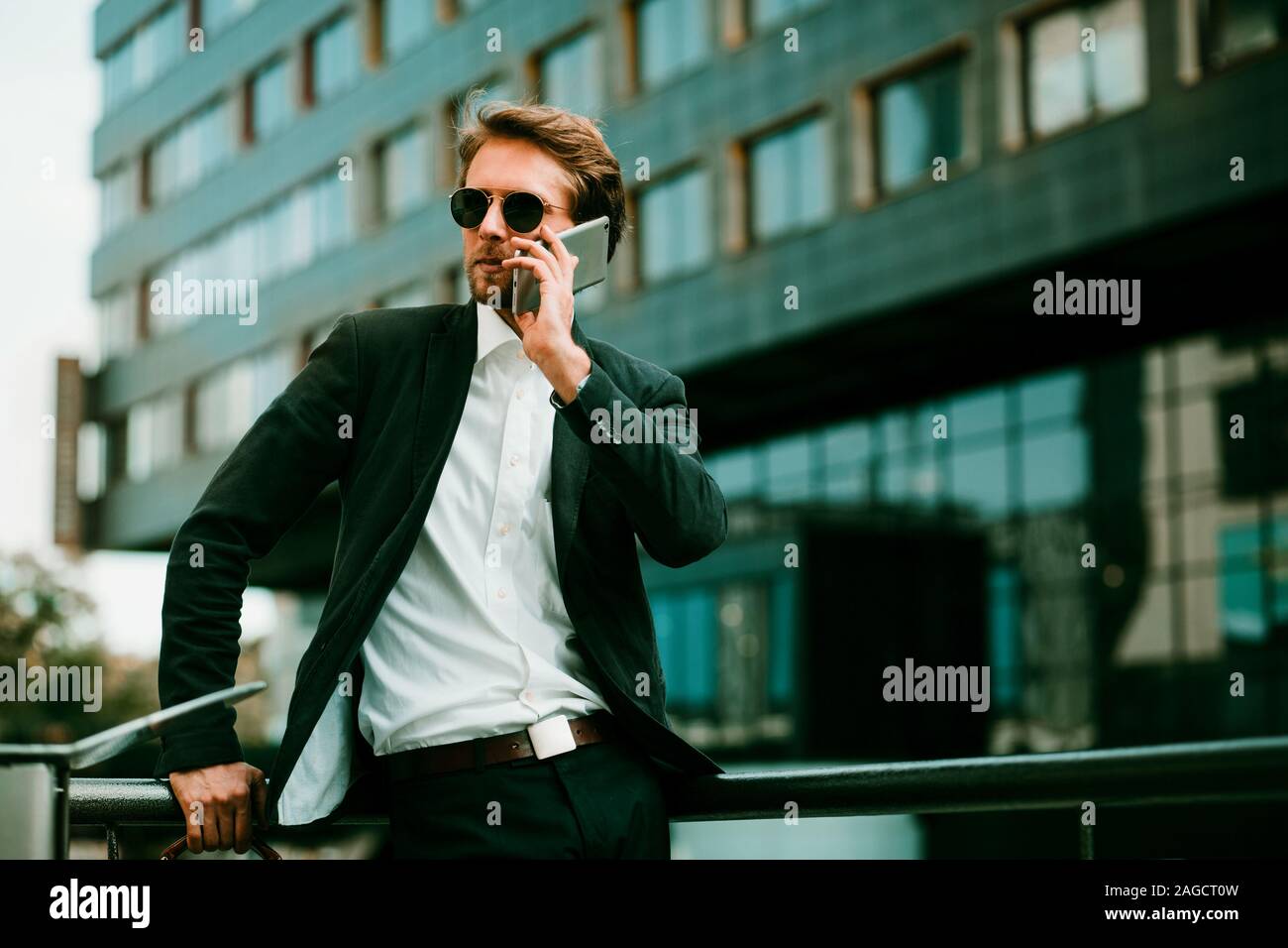 Elegant businessman leaning railing city hi-res stock photography and ...