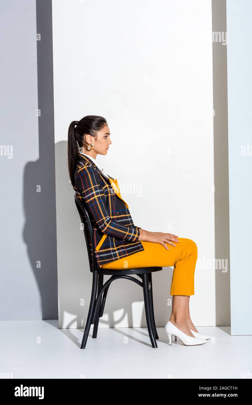 Young woman sitting side profile chair hi-res stock photography and ...