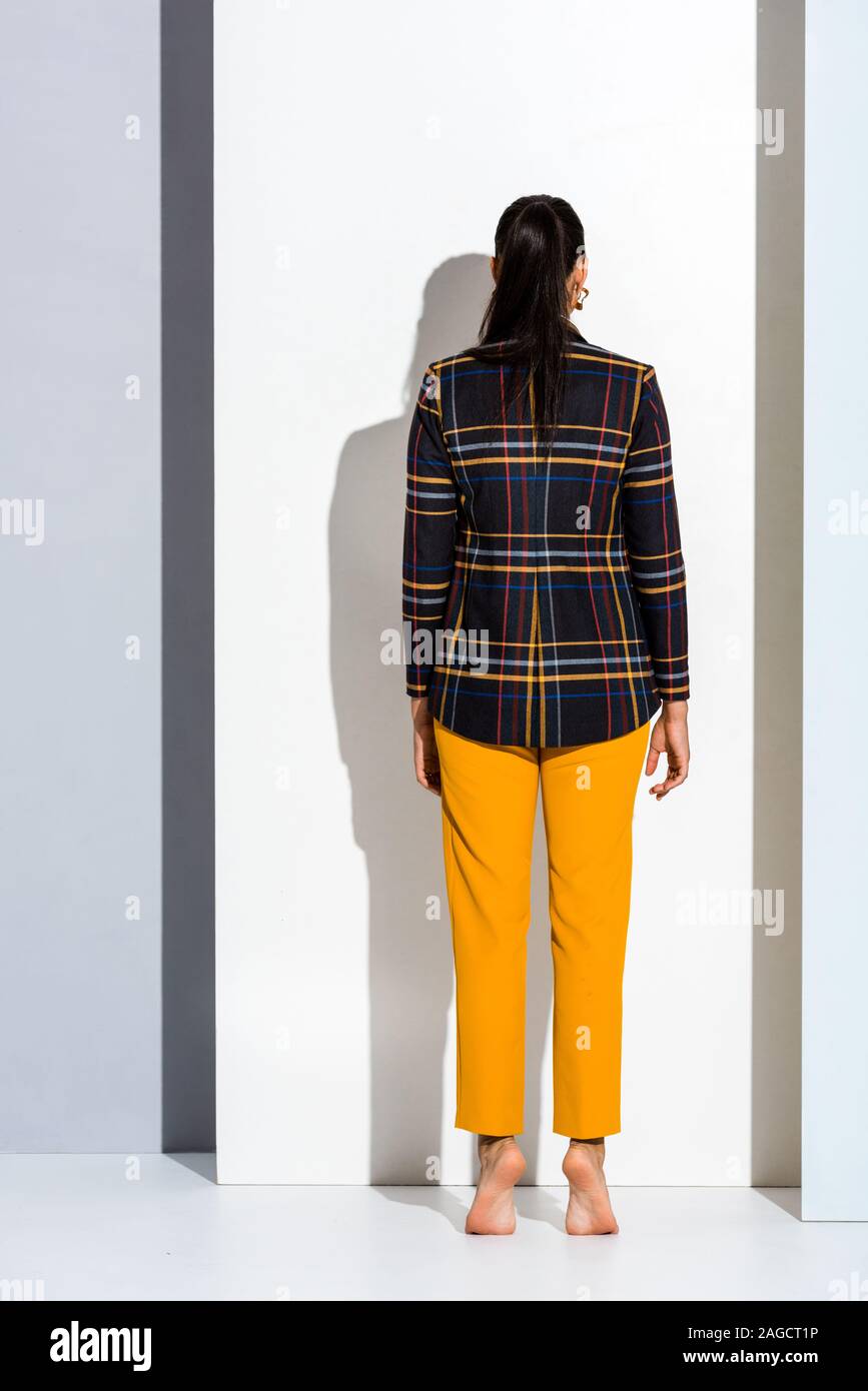 back view of woman with barefoot standing on grey and white Stock Photo ...