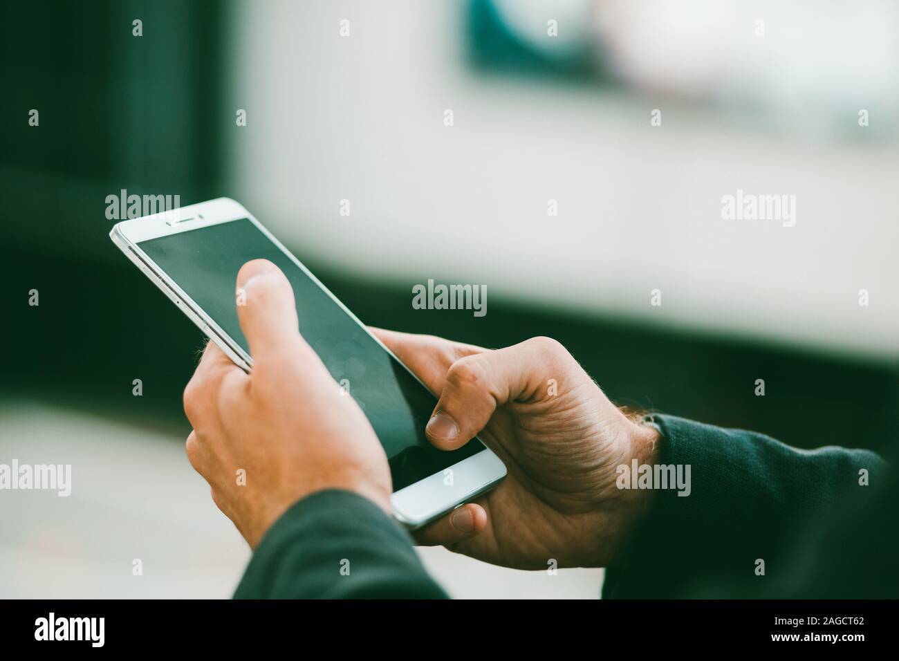 The Man Holding The Phone In His Hand Stock Photo - Alamy