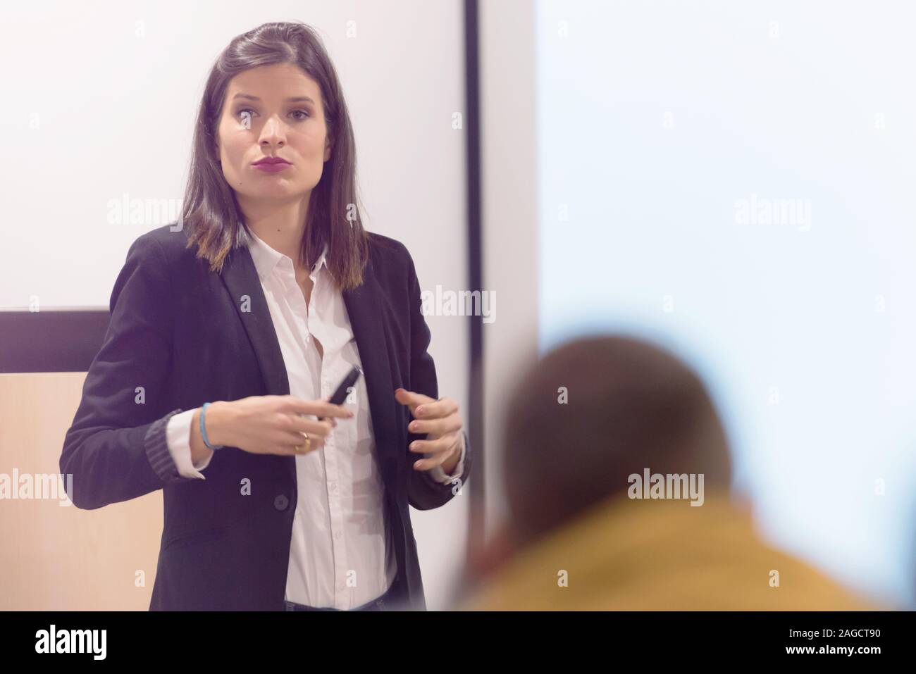 Pretty young businesswoman, teacher or mentor coach speaking to young ...