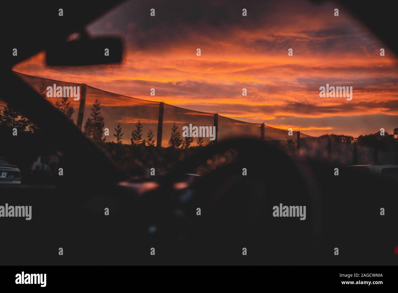 Beautiful scenery of the sunset sky taken through a car window in New ...