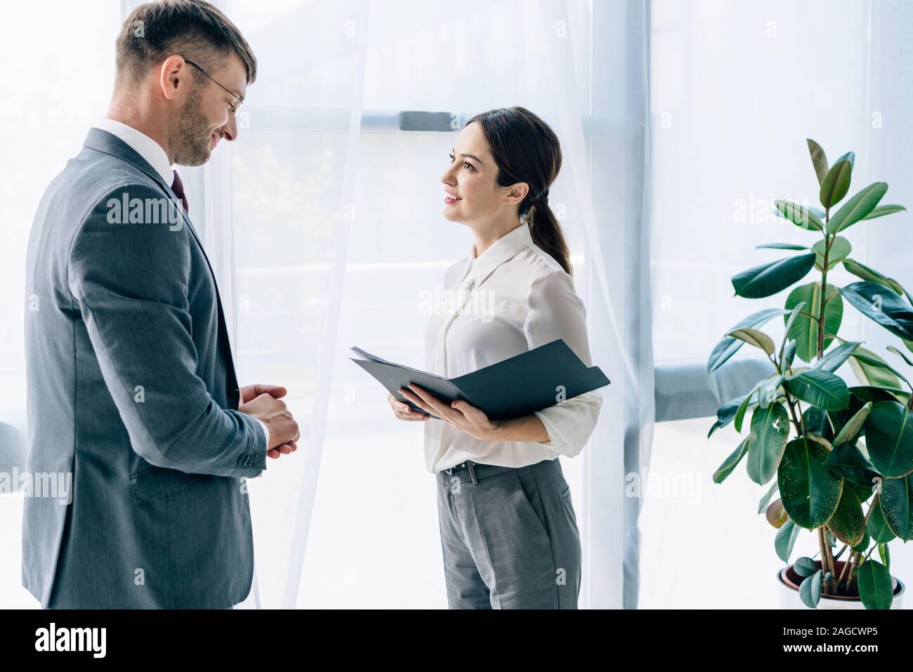 side view of journalist talking with businessman in formal wear Stock ...