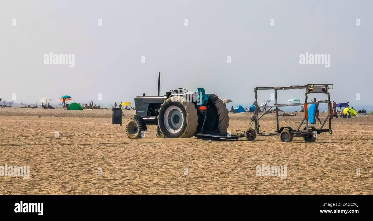 beach tractor with trailer parked on the beach of vrouwenpolder ...