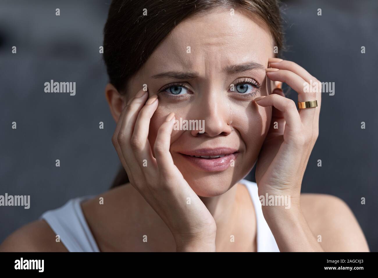 stressed young woman with ring crying and looking at camera Stock Photo ...