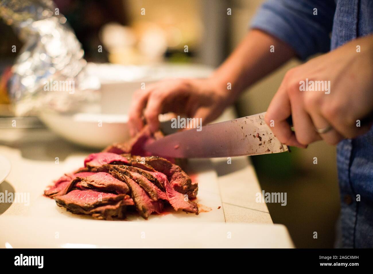 Man cutting ham in kitchen hi-res stock photography and images - Alamy