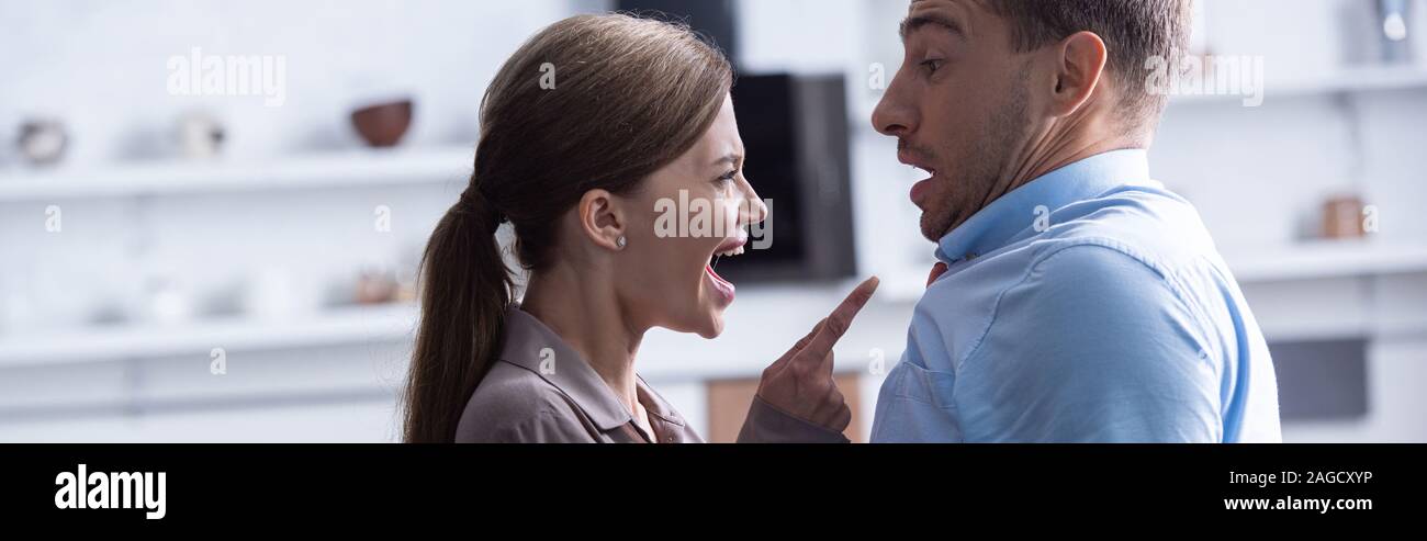 panoramic shot of angry woman yelling at scared husband Stock Photo - Alamy