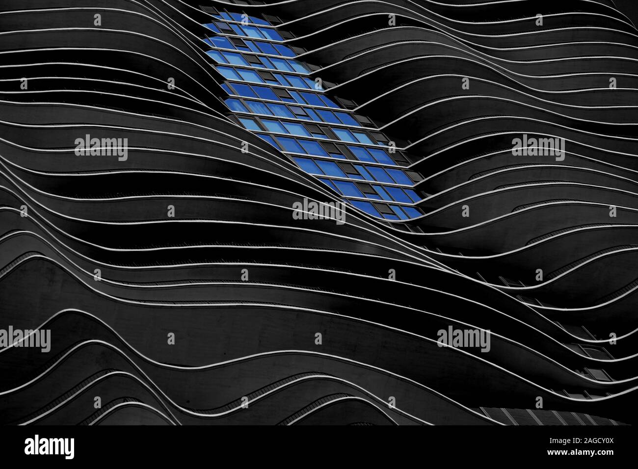 Modern style building with curvy and black walls and bright blue ...