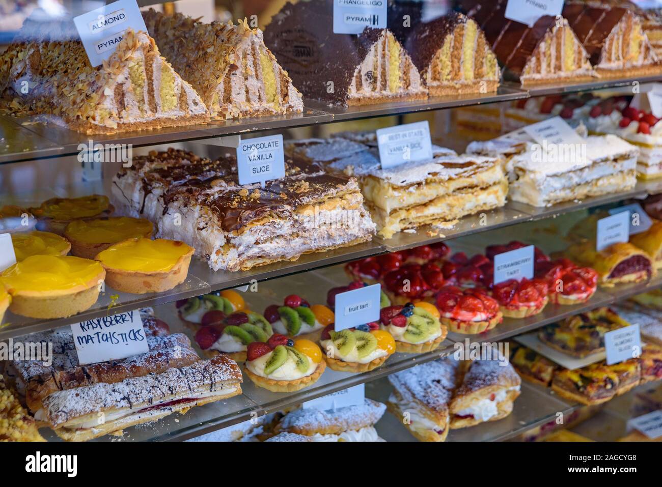 Desserts and cakes in window Stock Photo - Alamy