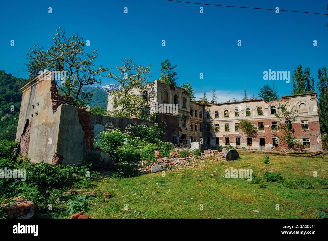 Ruined overgrown school in ghost mining town Akarmara, consequences of ...